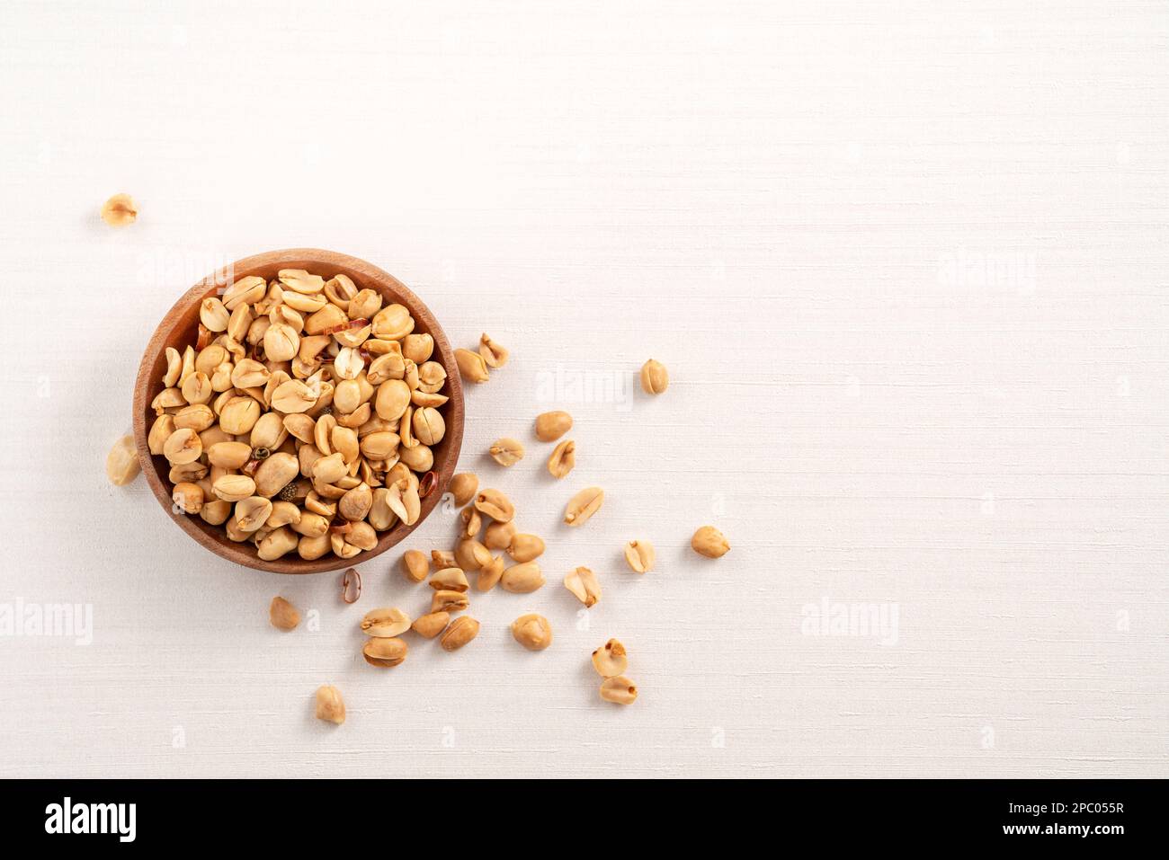 Spicy flavored peanut kernel in a bowl on white table background Stock ...