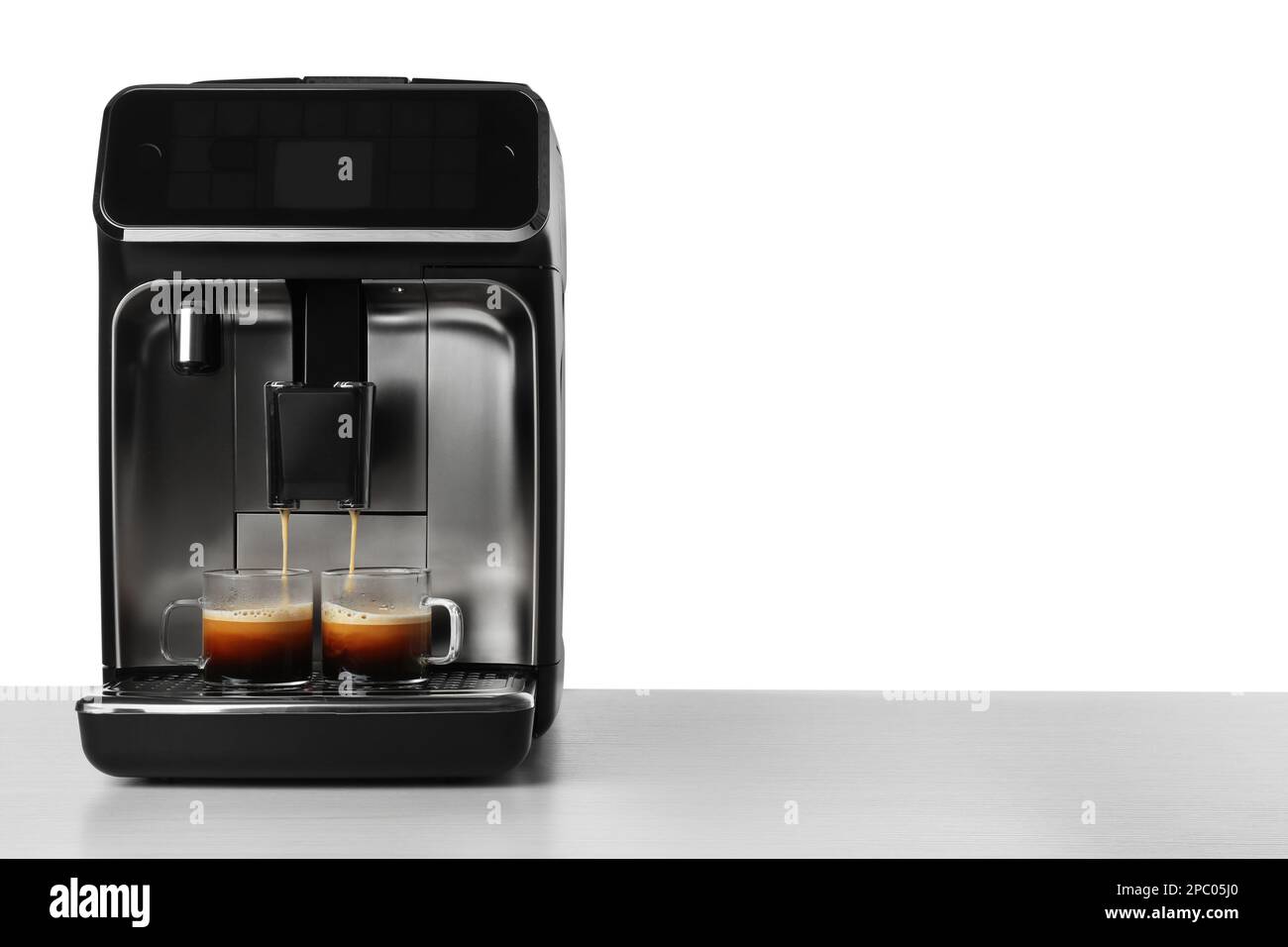 Making coffee with modern espresso machine on table against white ...