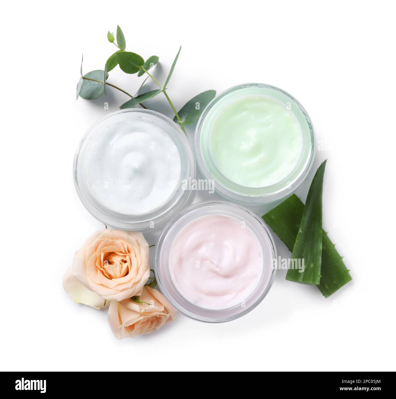 Different body creams with ingredients on white background, top view ...