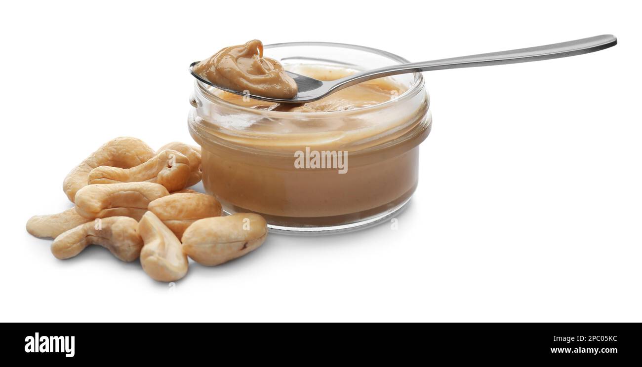 Jar and spoon with delicious cashew butter on white background Stock ...