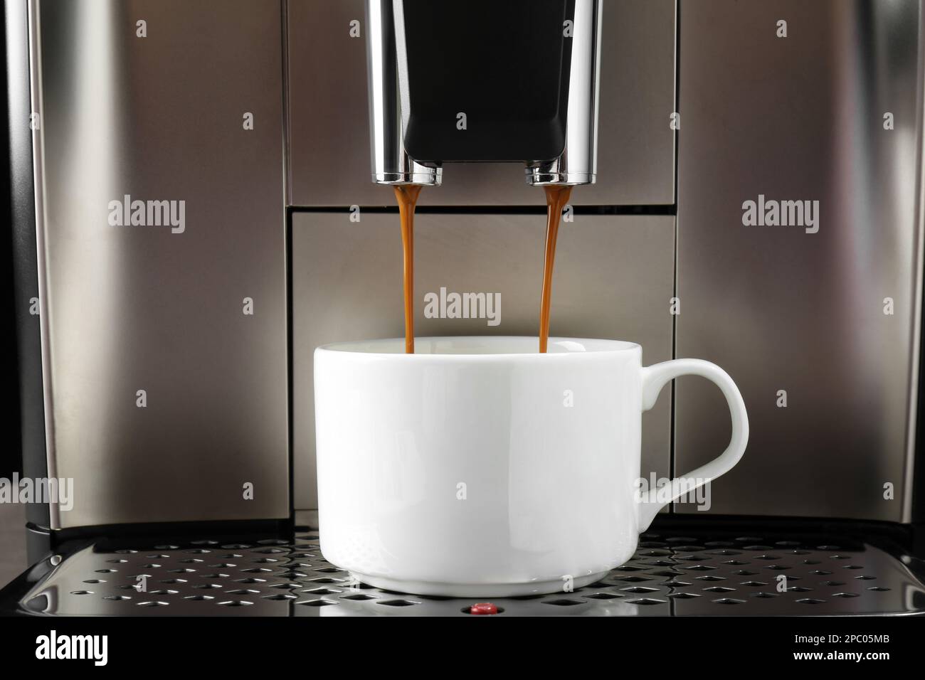 Modern espresso machine pouring coffee into cup, closeup Stock Photo ...