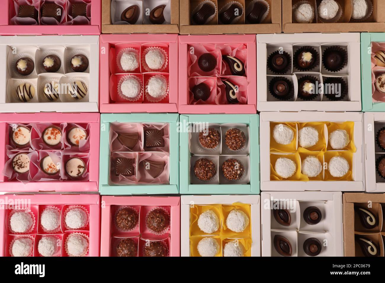 Many delicious candies in boxes, top view. Production line Stock Photo ...