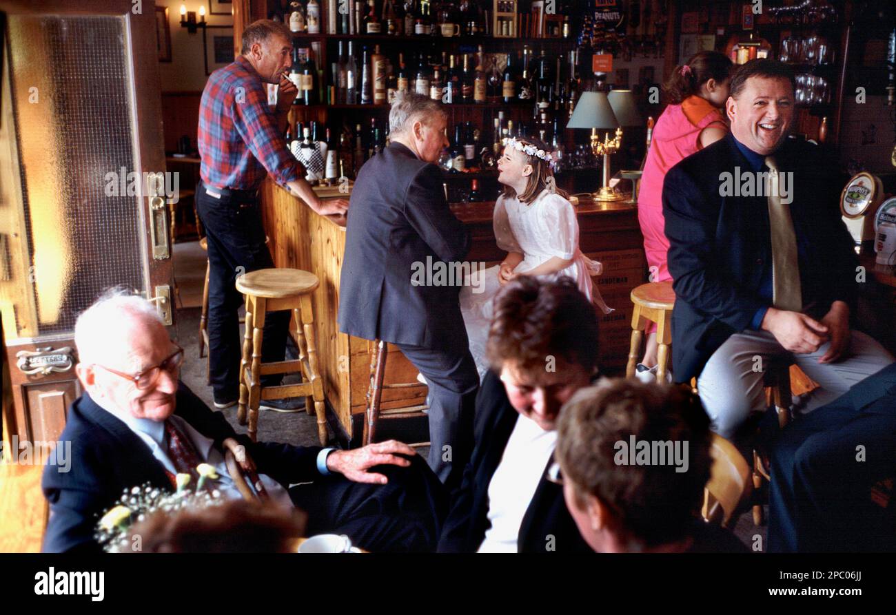 After her first communion, a girl and her family gather after Mass at ...