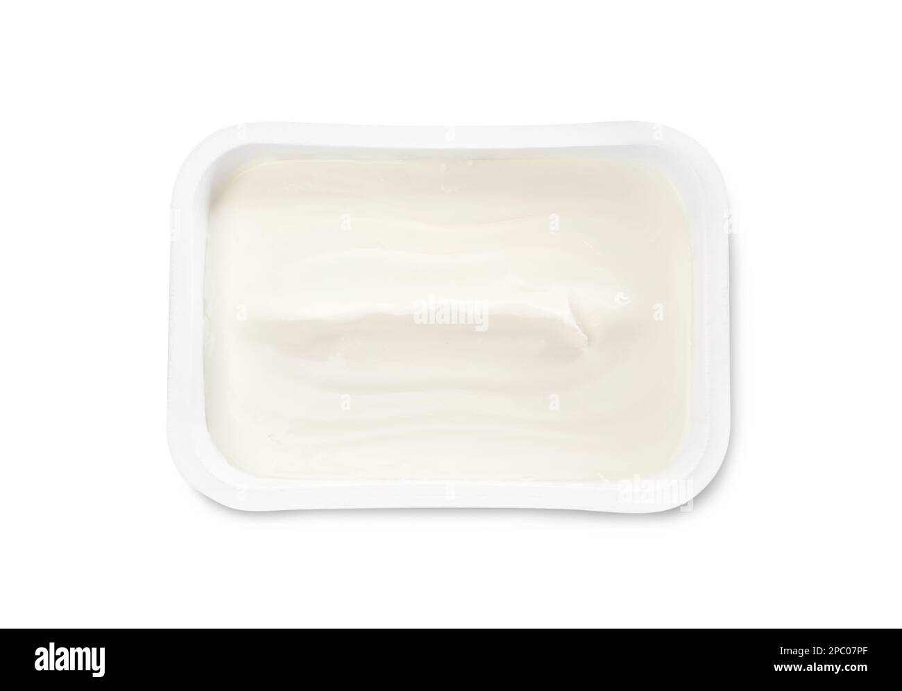 Plastic container of tasty cream cheese isolated on white, top view ...