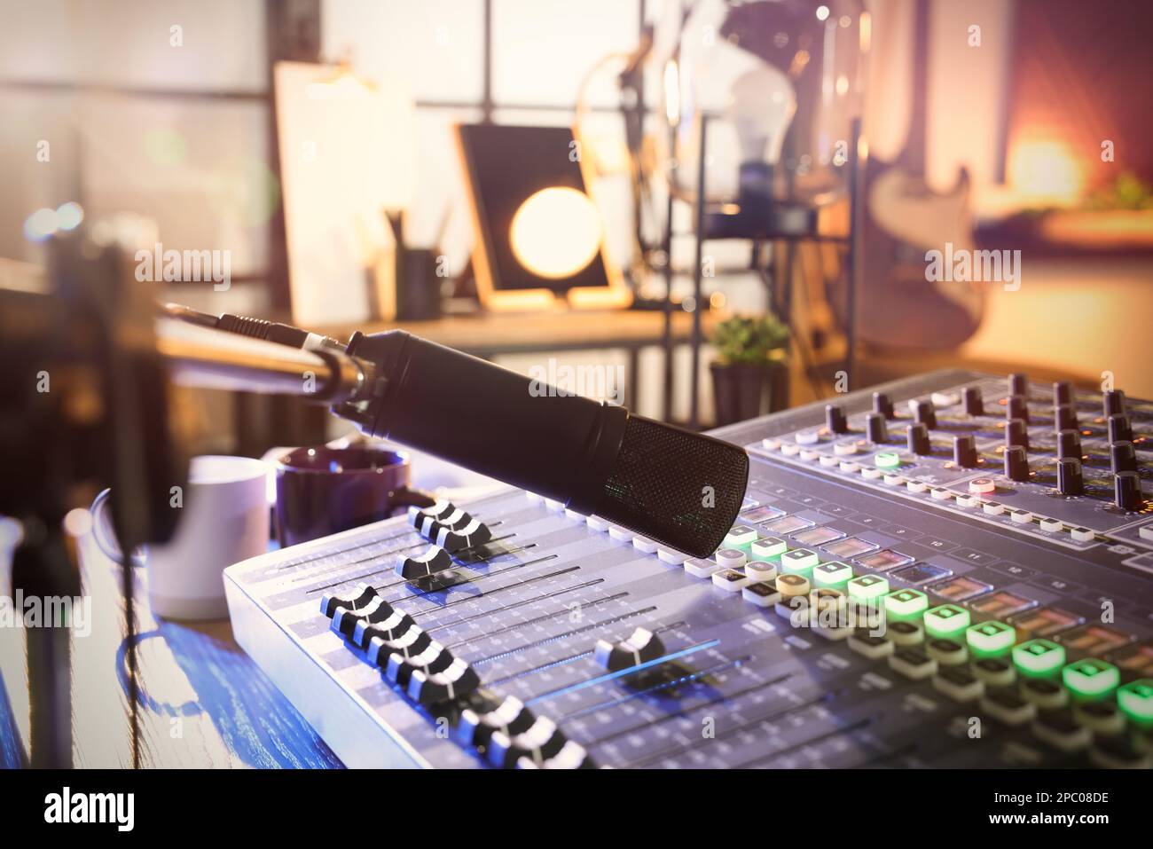 Microphone over professional mixing console on table in radio studio ...