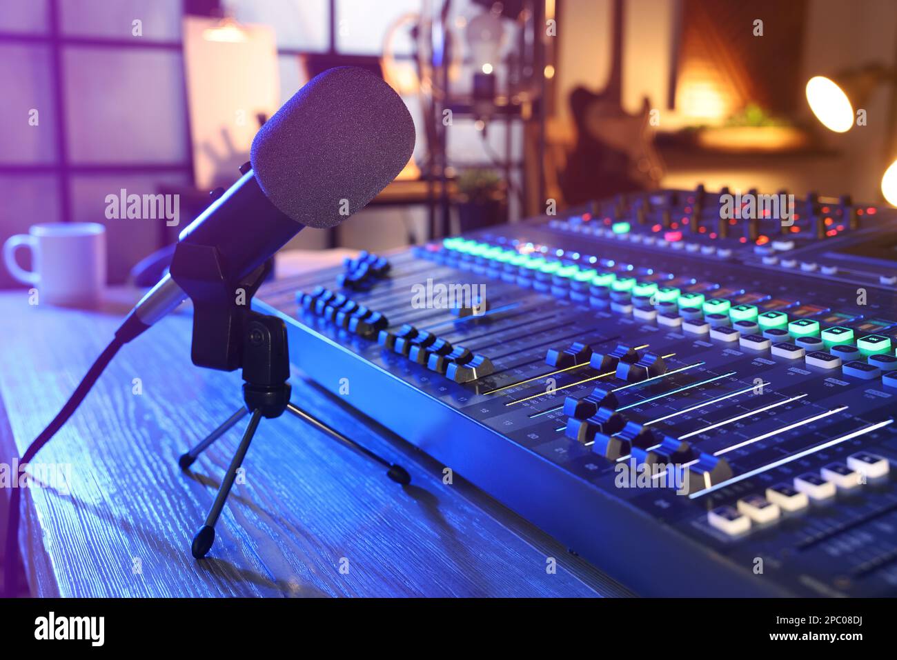 Microphone and professional mixing console on table in radio studio ...