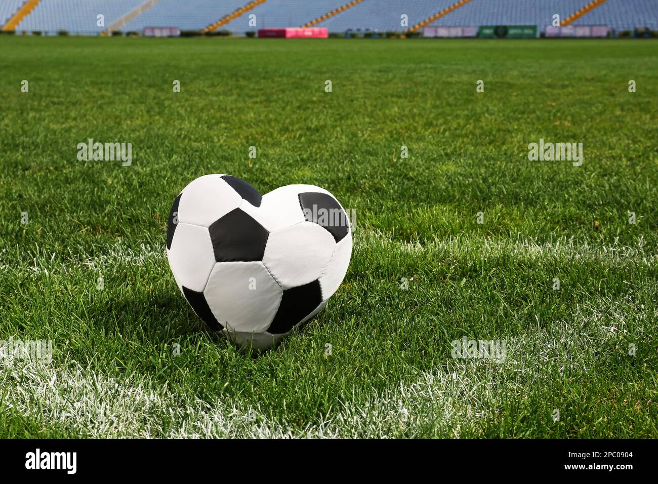 Heart shaped soccer ball on green field at stadium Stock Photo - Alamy