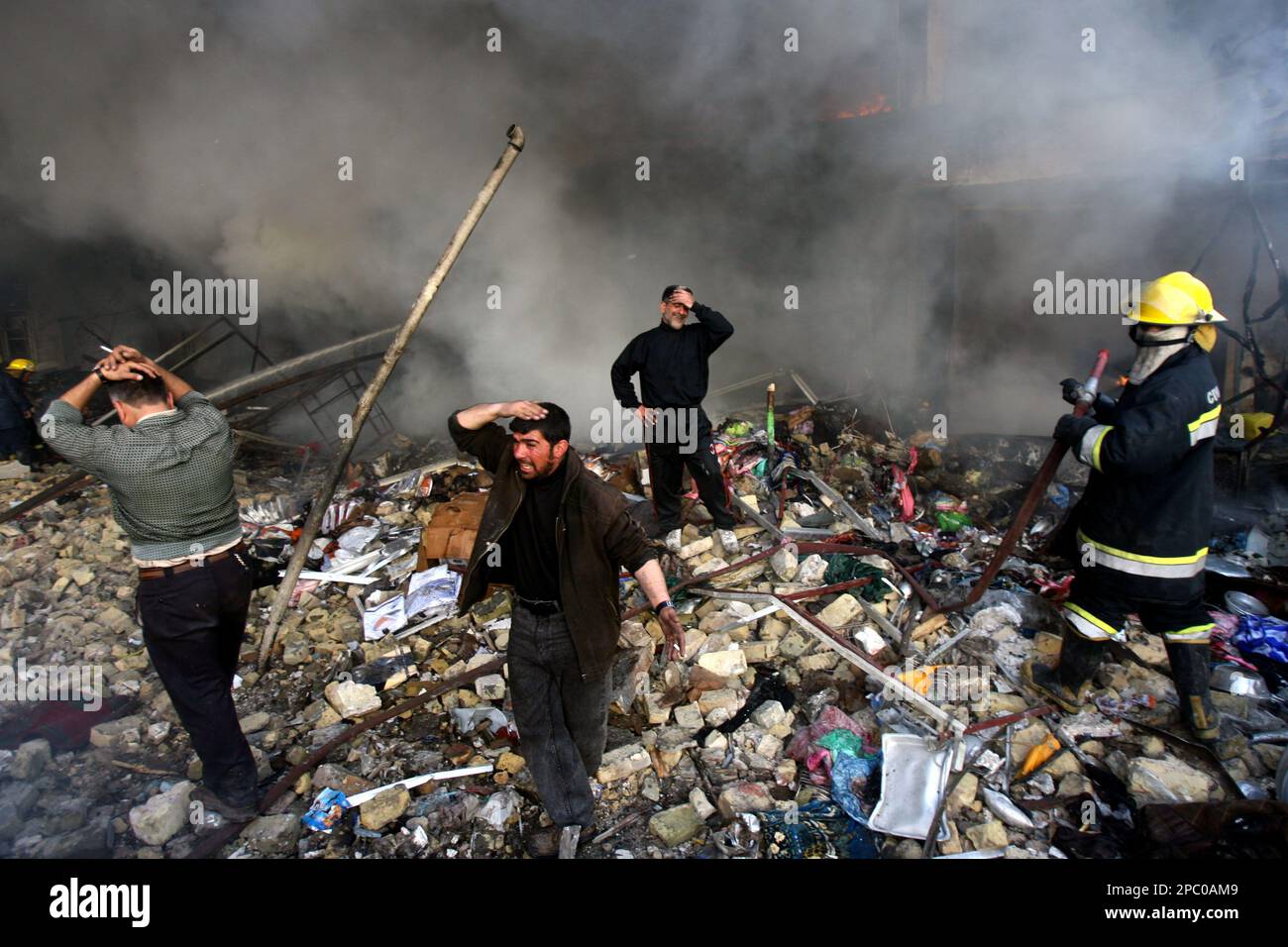 Iraqis grieve amid the rubble after a double car bomb attack in central ...