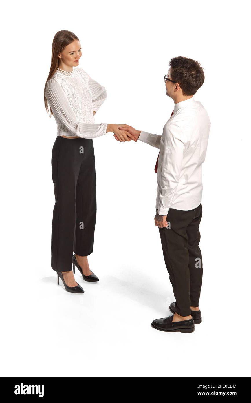 Two people, man and woman in business style clothes interact with each ...