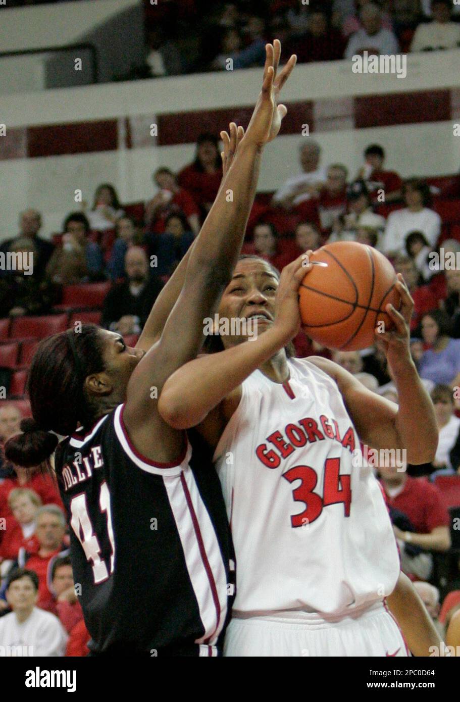 Georgia's Tasha Humphrey, right, puts up a shot over South Carolina's ...