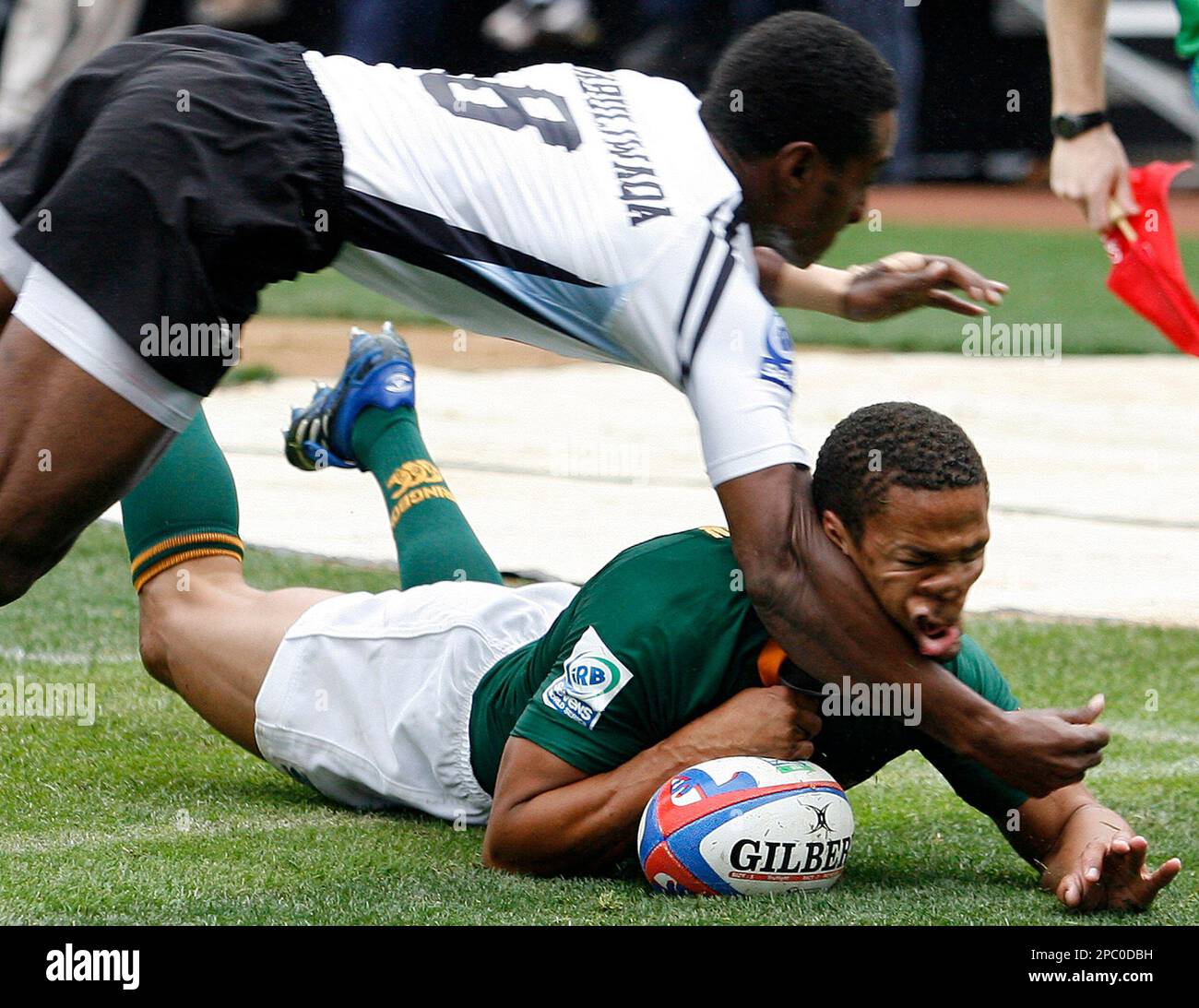 South Africa's Ryno Benjamin, right, is hit by Fiji's Lepani Nabuliwaqa ...