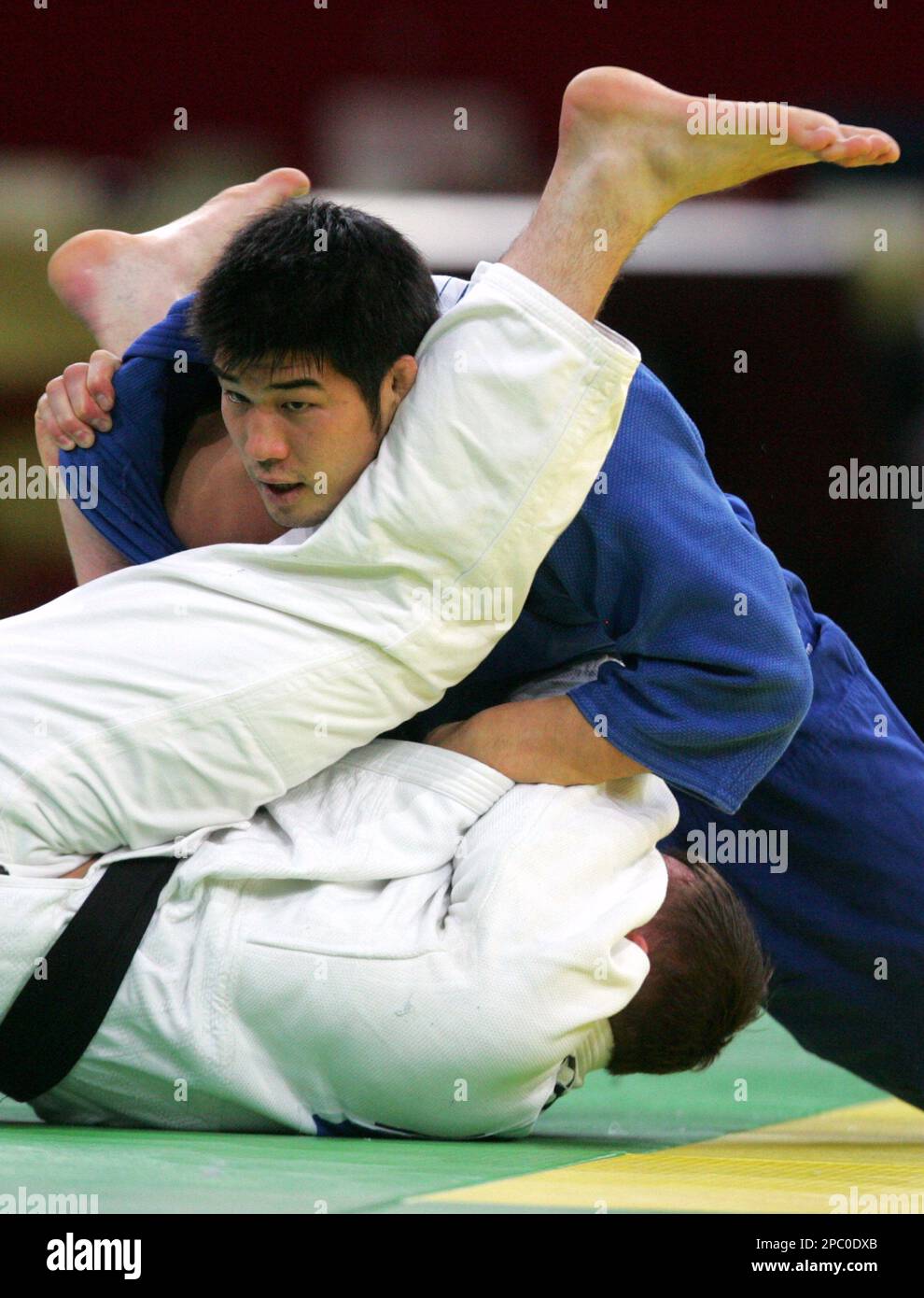 Japan's Inoue Kossei, top, and Belarus' Yury Rybak take part in the men's over 100-kg final ...