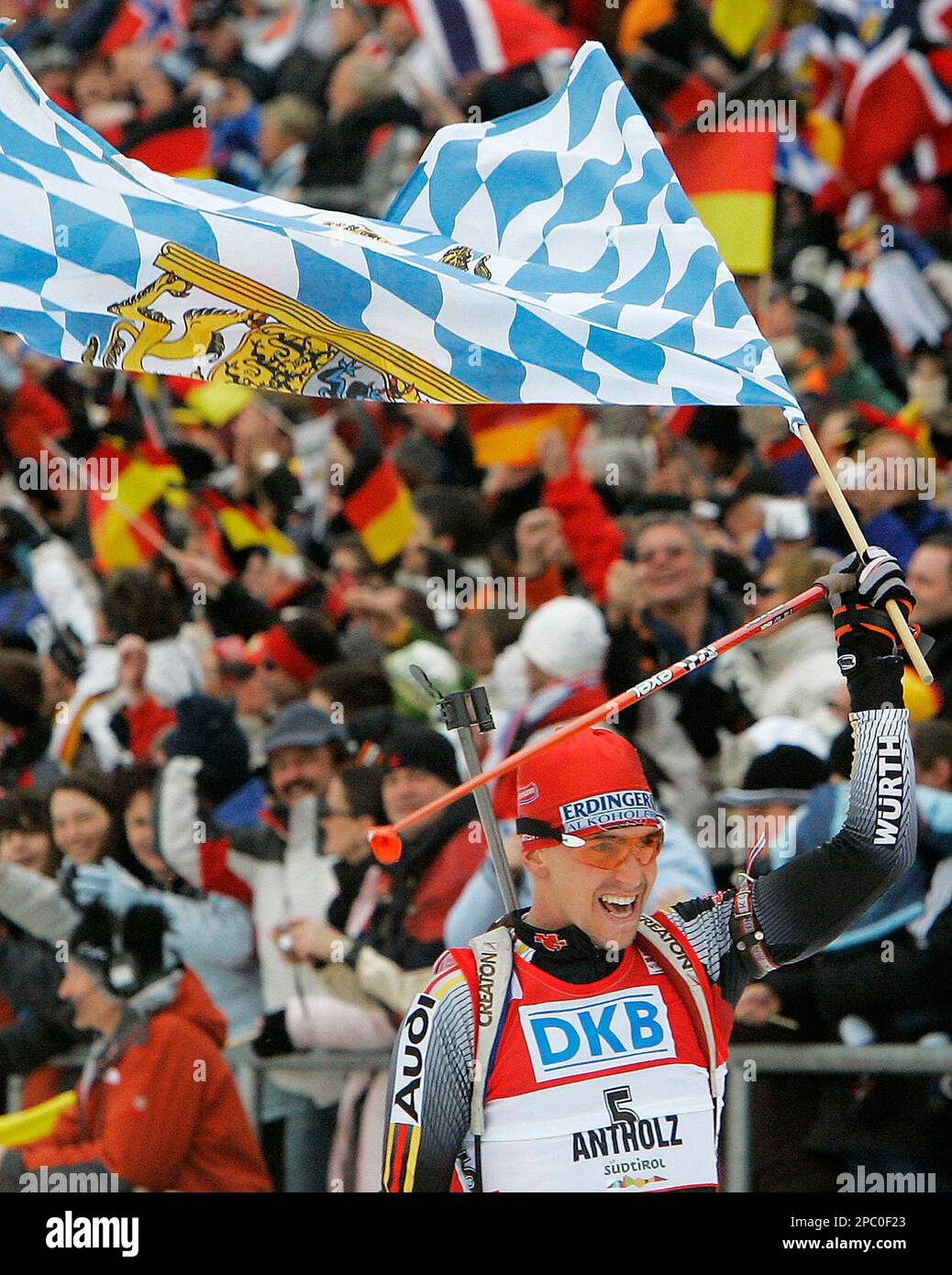 Germany's Michael Greis celebrates with the Bavarian flag as he crosses ...