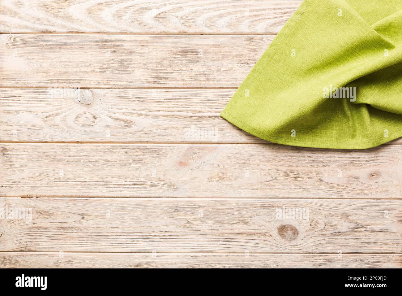top view with green kitchen napkin isolated on table background. Folded ...