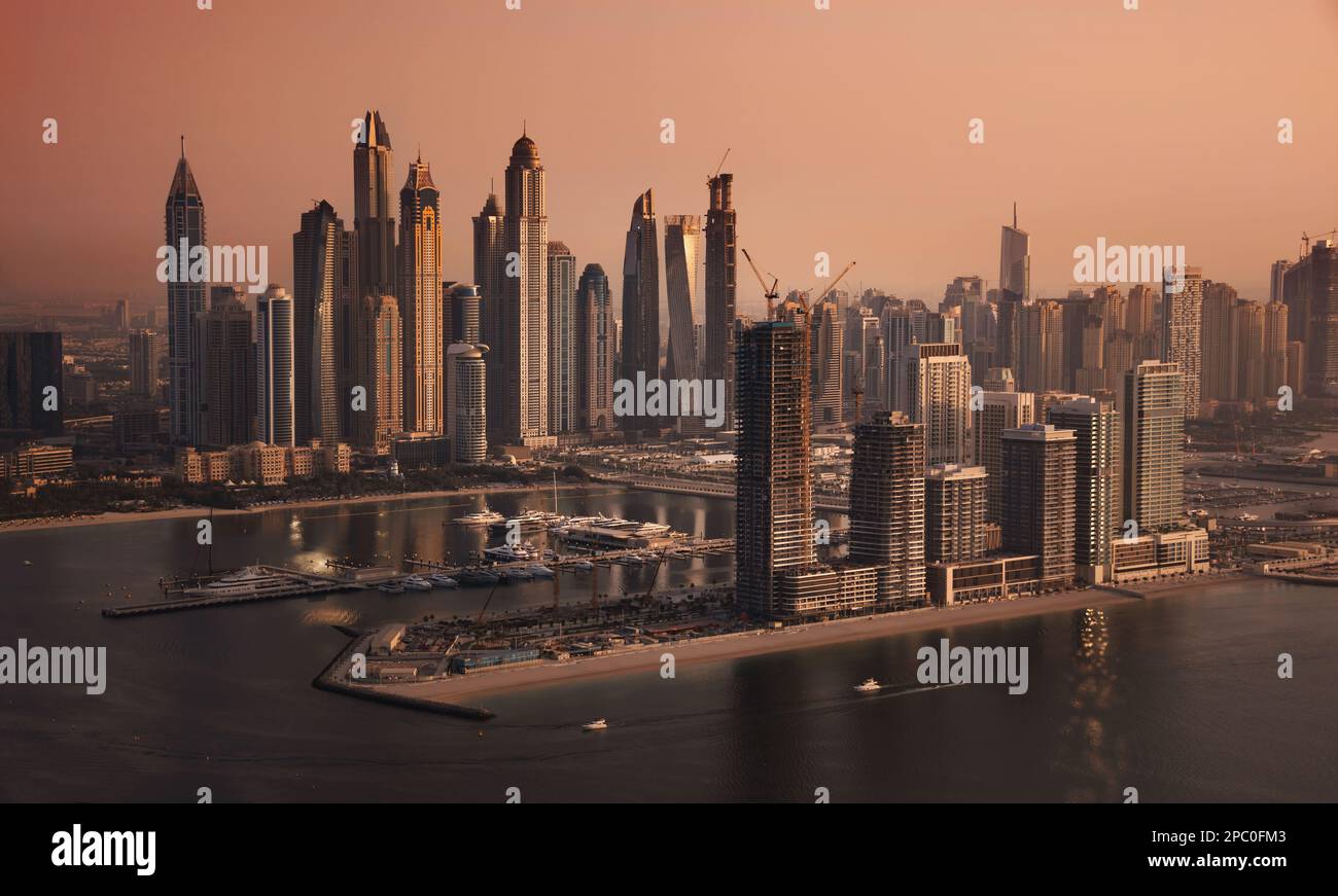 Dubai skyline on sunset, modern city with skyscrapers seen from water ...