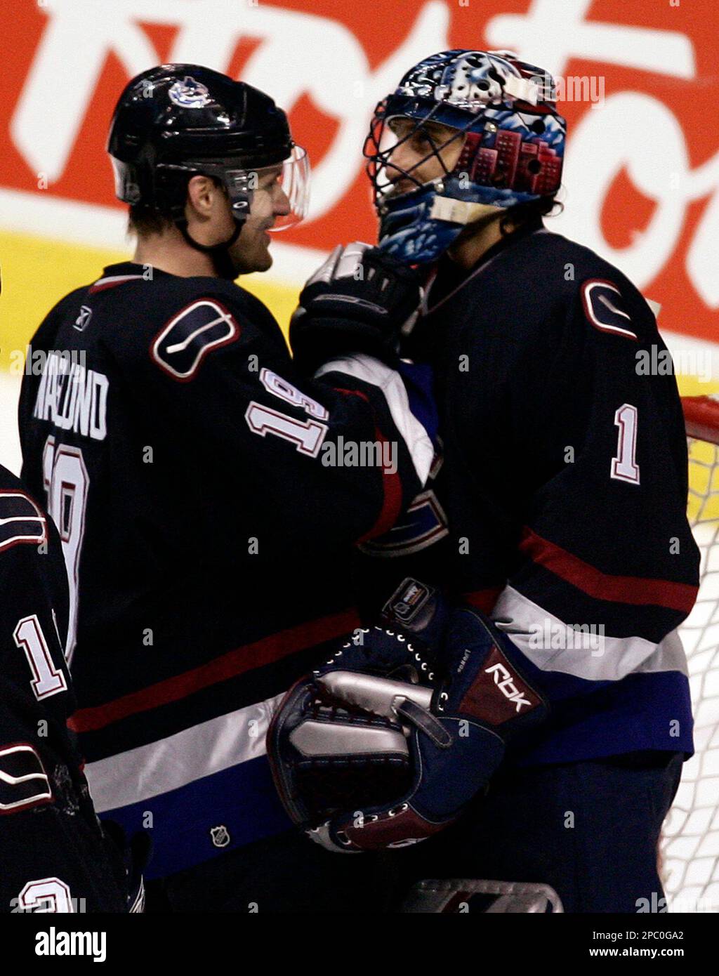 Vancouver Canucks' Markus Naslund, left, congratulates teammate Roberto ...