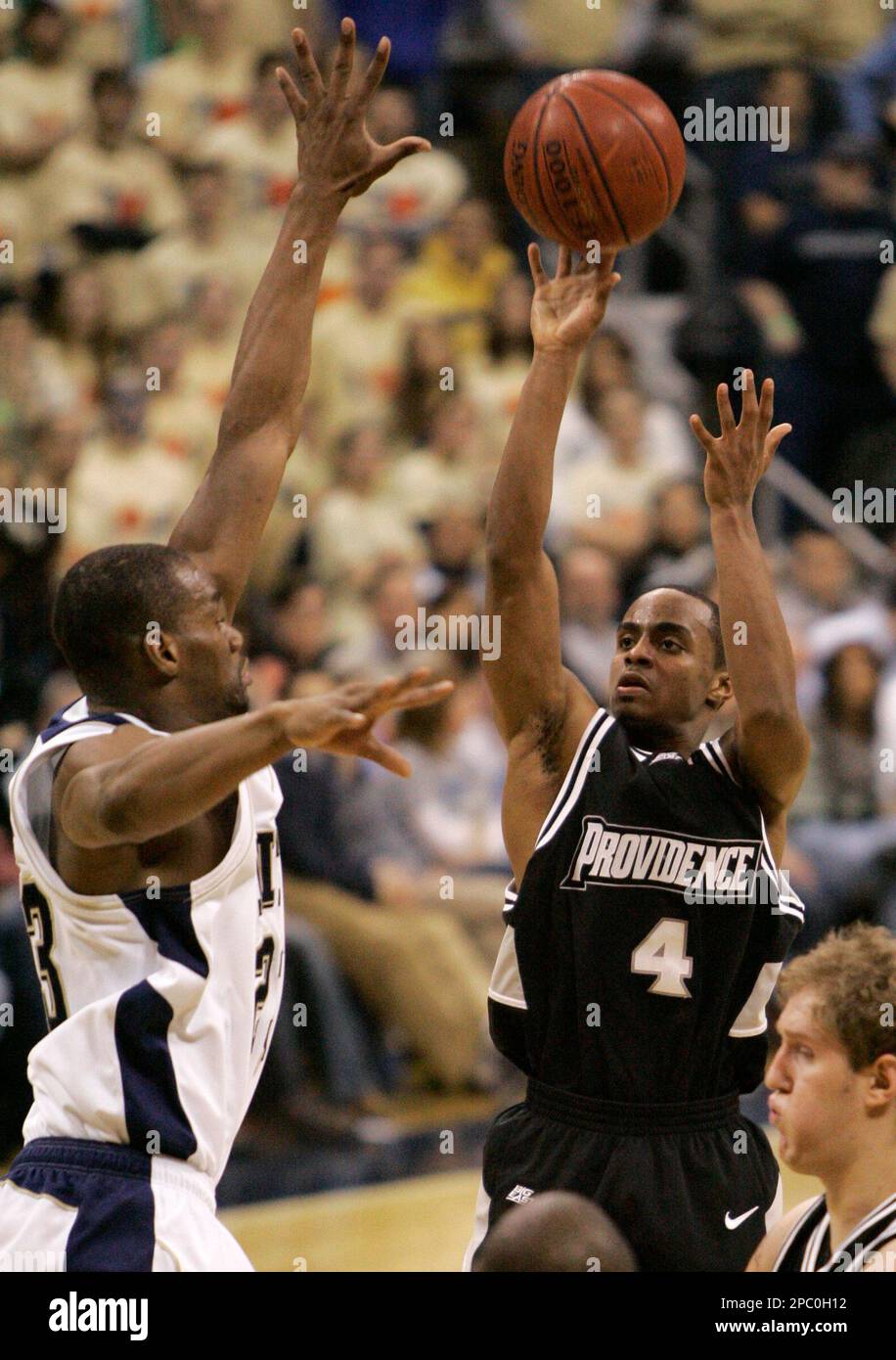 Providence's Sharaud Curry, right, shoots over Pittsburgh's Sam Young ...