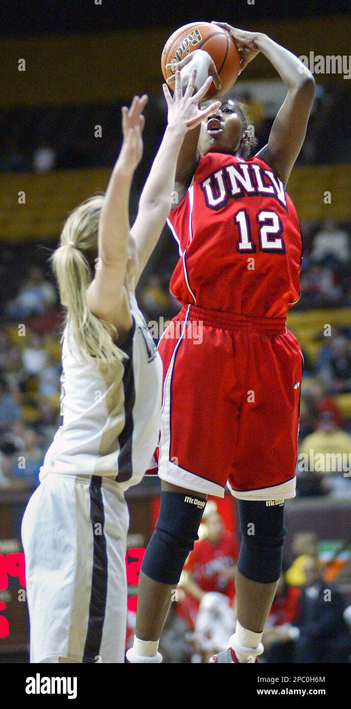UNLV's Sequoia Holmes (12) shoots while guarded by Wyoming's Hanna Zavecz during a Mountain West ...