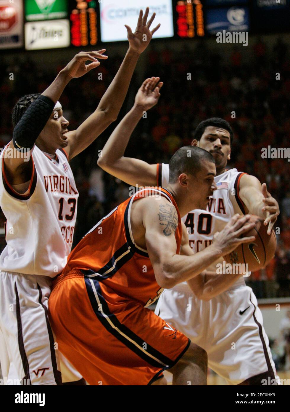 Virginia Tech's Deron Washington (13) and A.D. Vassallo (40) apply ...