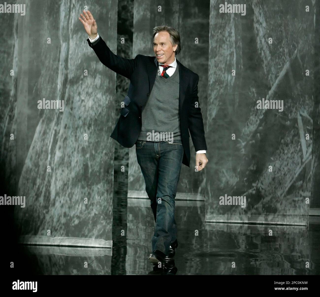 Designer Tommy Hilfiger waves to the audience after showing his ...