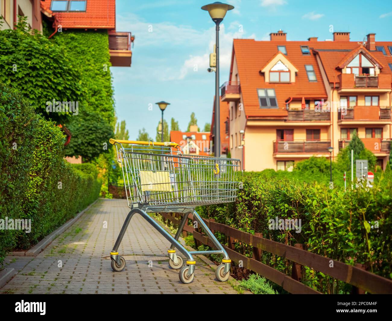 empty trolley shopping cart outside near apartment house entrance ...