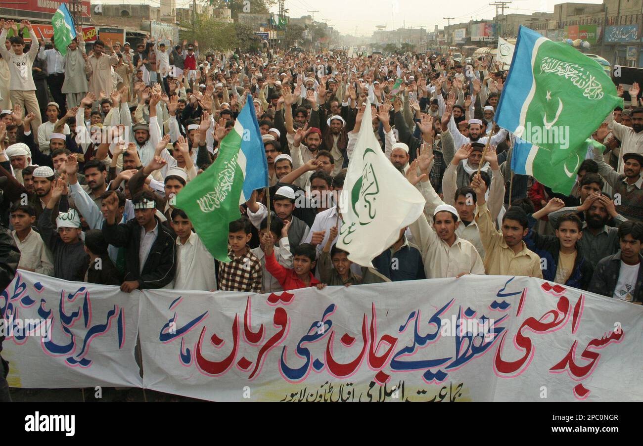 Pakistani protesters carry various Islamic flags and chant slogans to ...