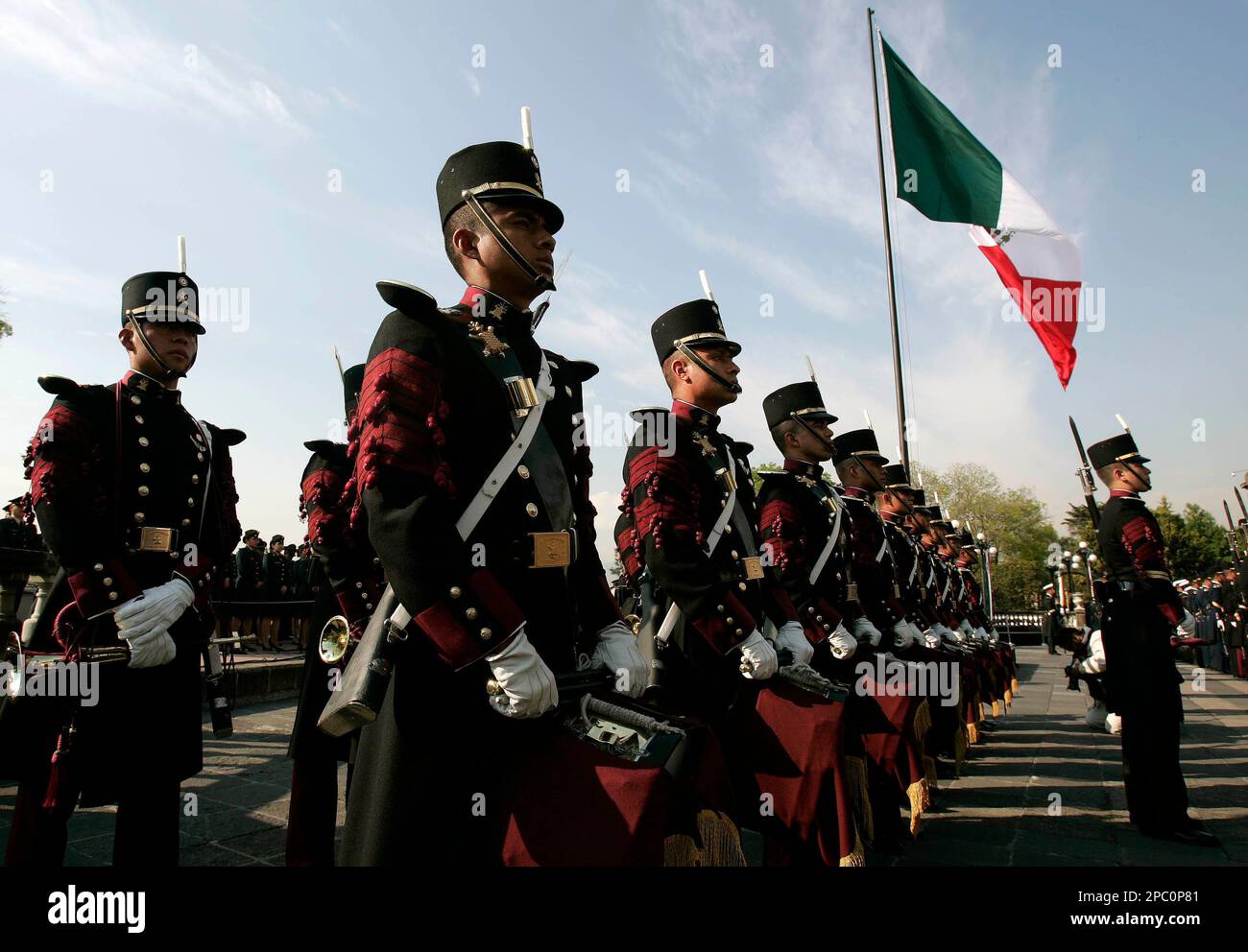 Mexican military troops in their formal uniforms stand at attention ...