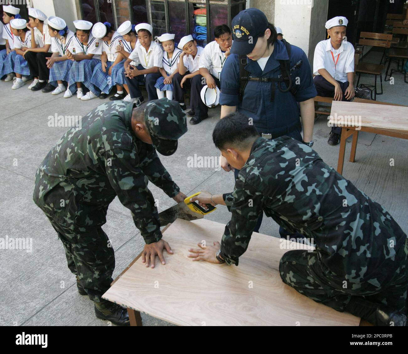 Autistic Filipino children, wearing sailor's hats, watch as Filipino ...