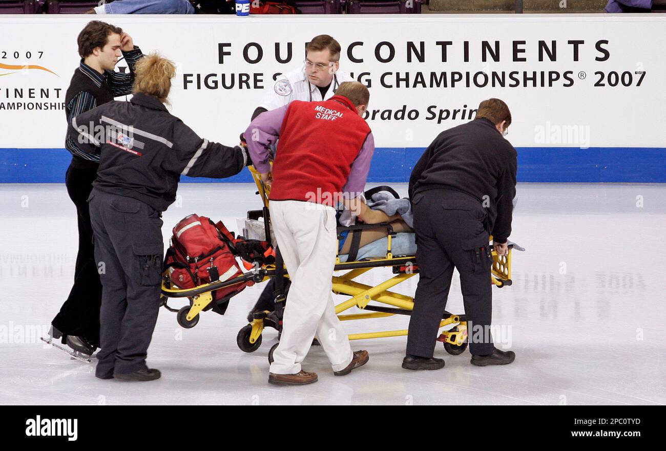 Bryce Davison, left, follows as his partner Jessica Dube as she is ...