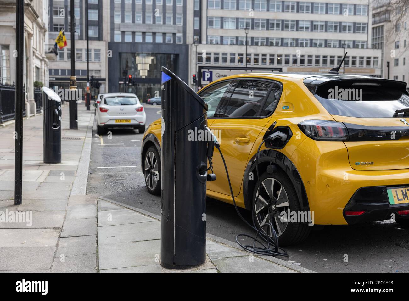 Electric vehicles parked on a street charging bay, in Cavendish Square ...