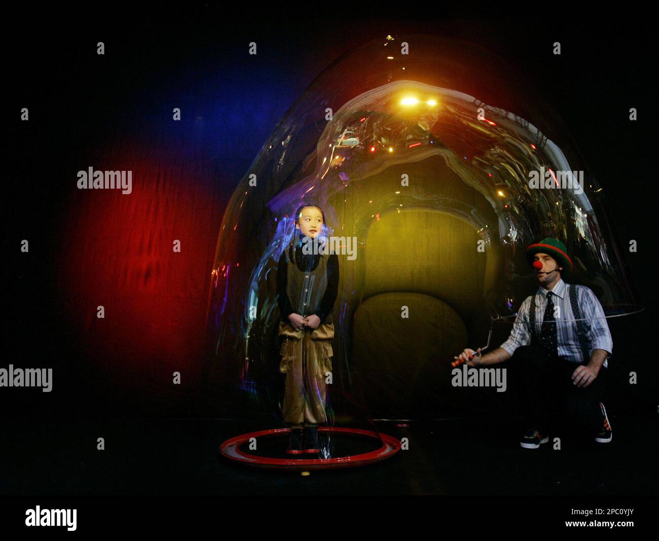 Australian Bubble Mania Master, Andrew Suttar, right, puts a giant ...