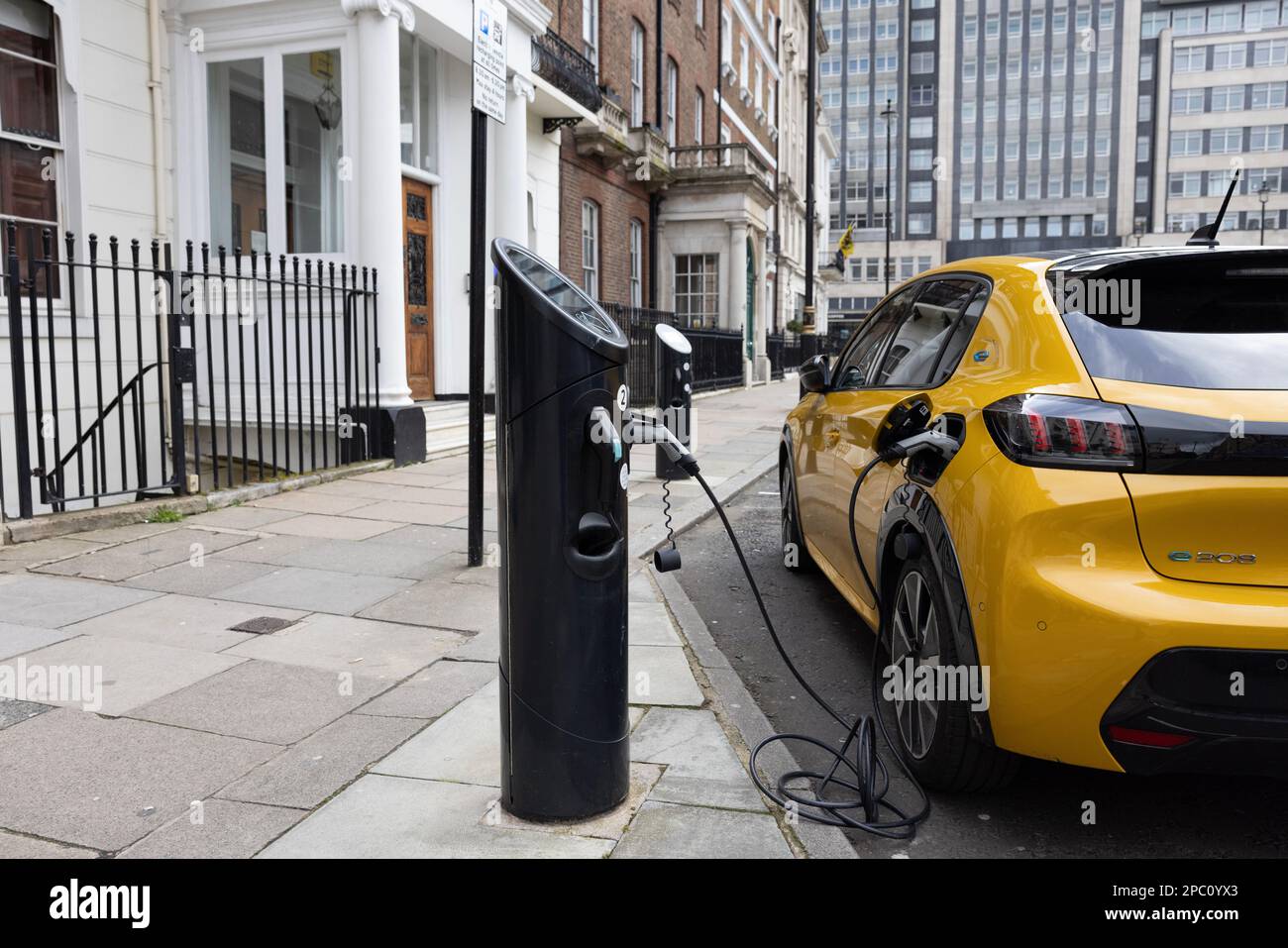Electric vehicles parked on a street charging bay, in Cavendish Square ...
