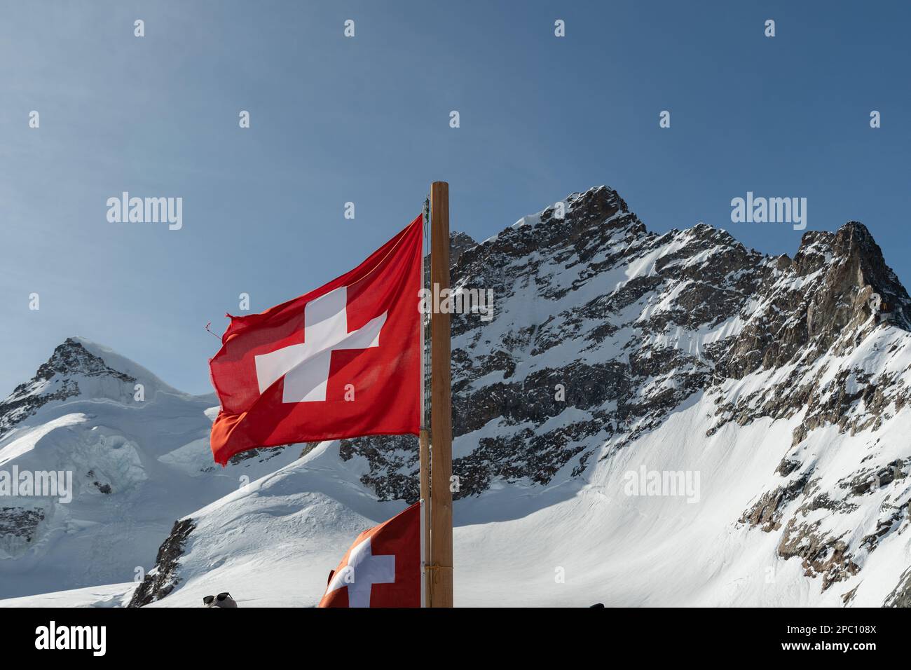Jungfraujoch, Canton Bern, Switzerland, February 11, 2023 Waving swiss ...