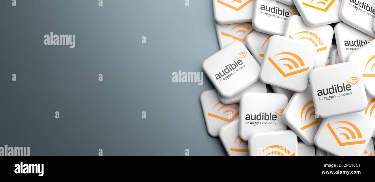 Logos of Audible the audio book and podcast service by Amazon on a heap ...