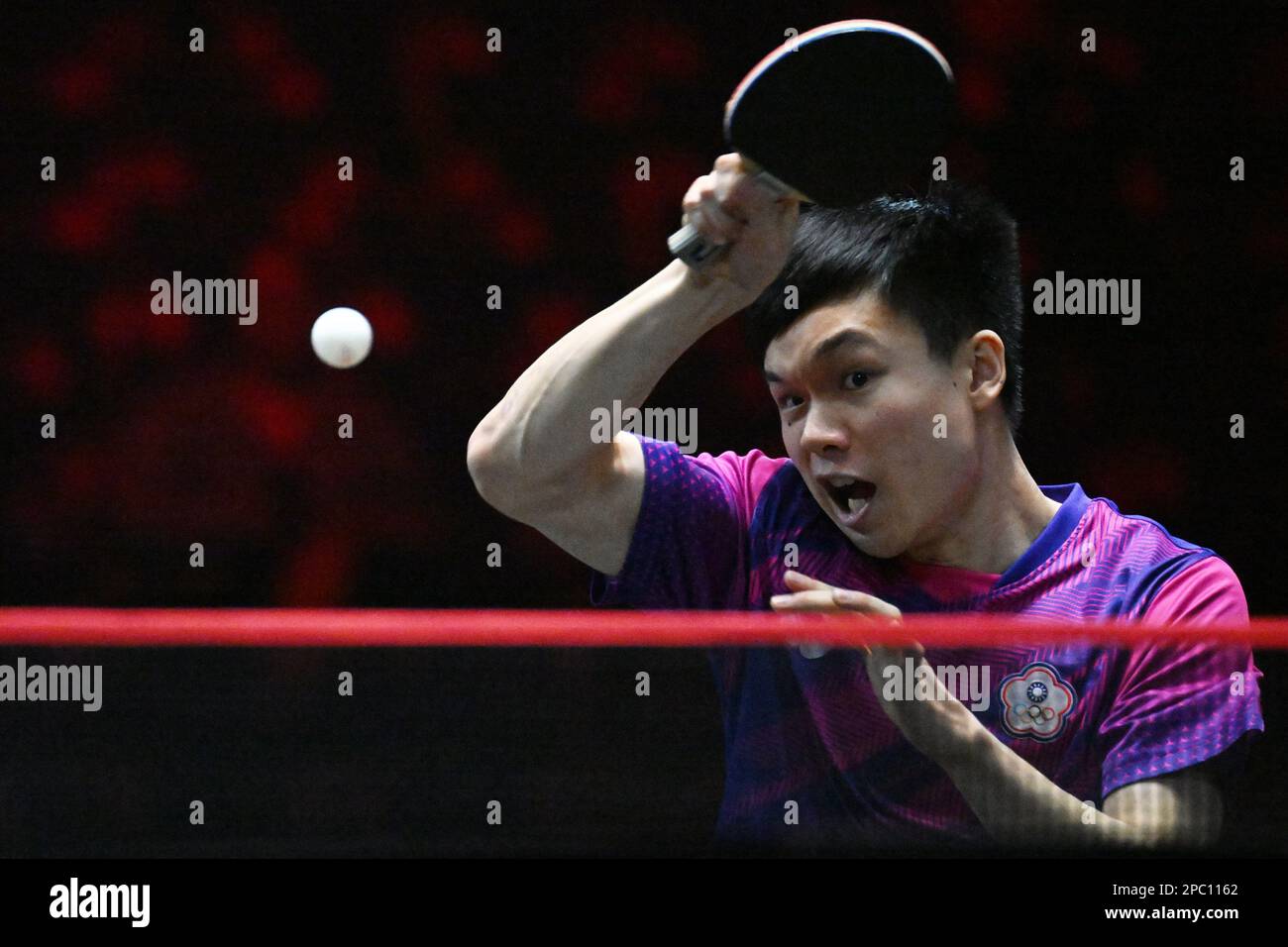 Singapore. 13th Mar, 2023. Feng Yi-Hsin of Chinese Taipei hits a return during the men's singles ...