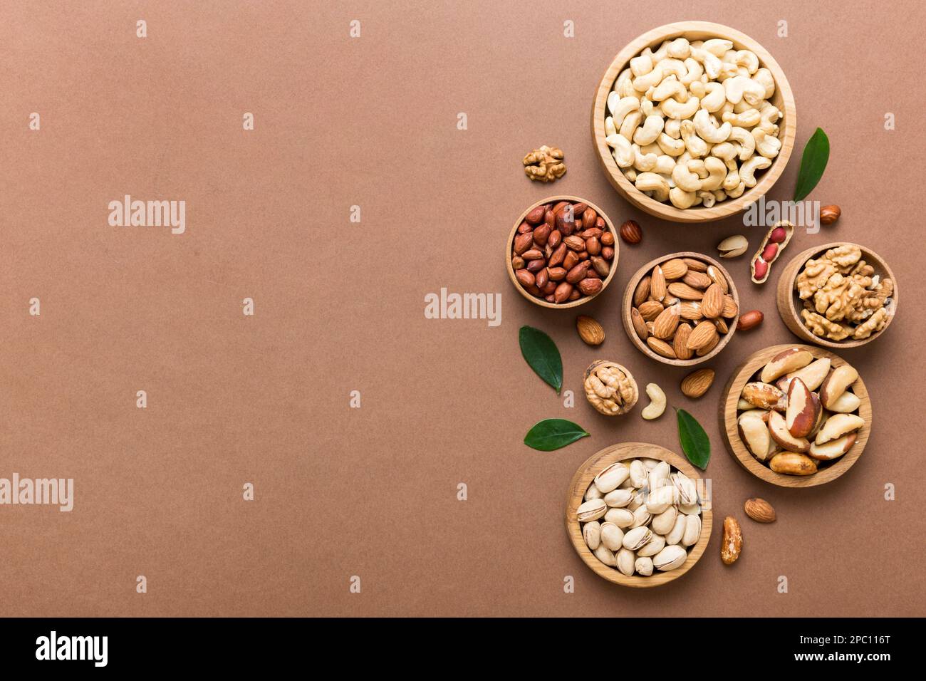 mixed nuts in wooden bowl. Mix of various nuts on colored background ...