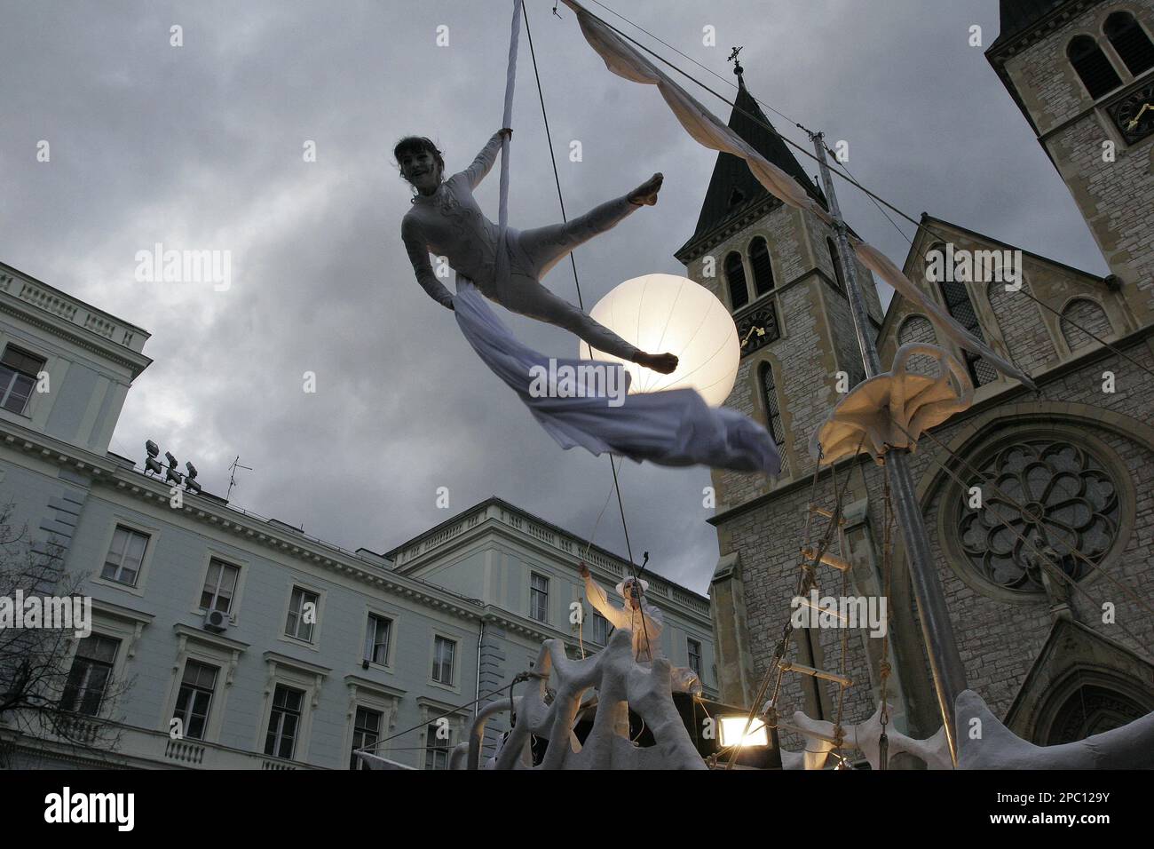 A group of actors and musicians perform in a street parade during the ...