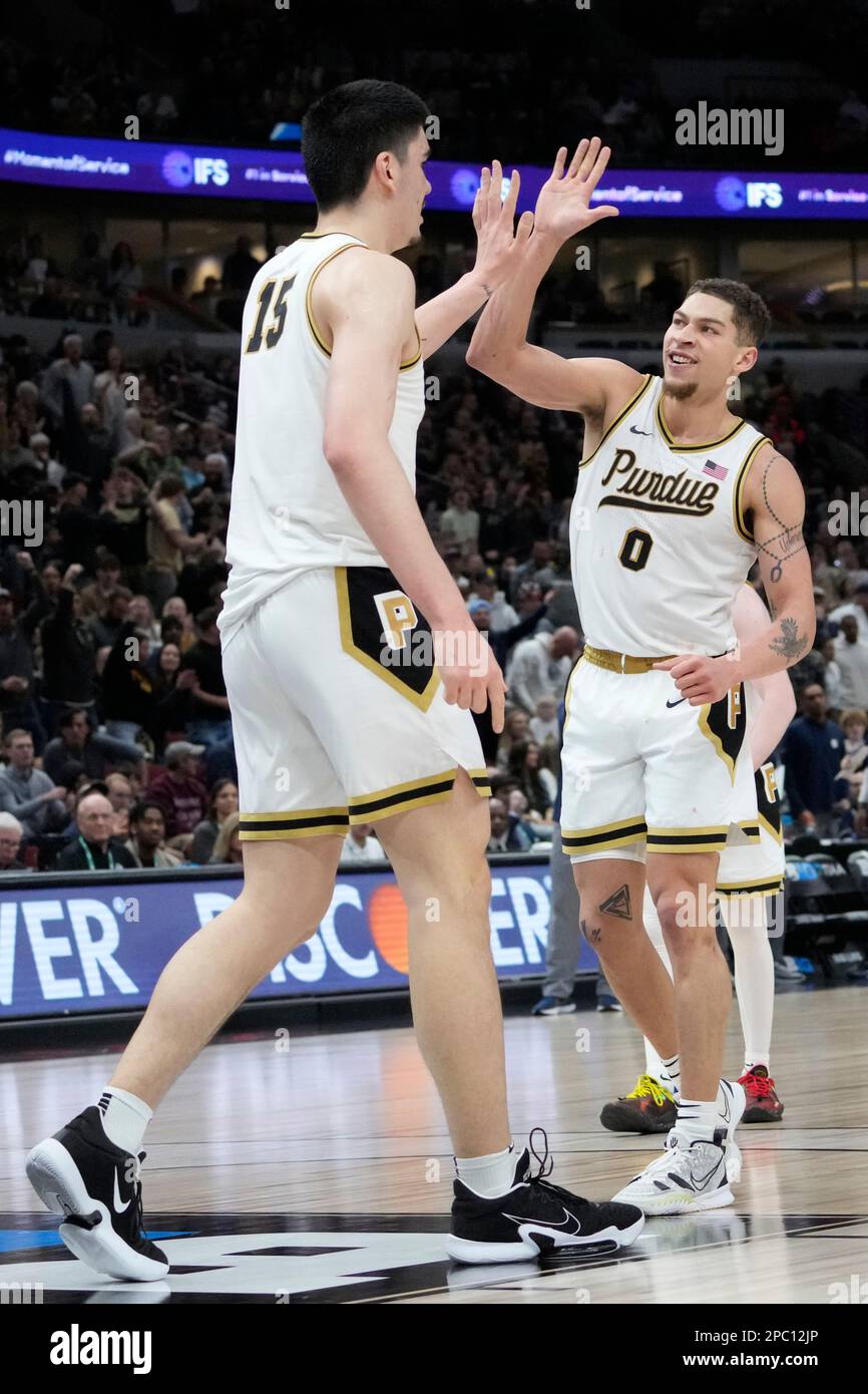 Purdue's Zach Edey (15) high fives Mason Gillis during an NCAA college ...