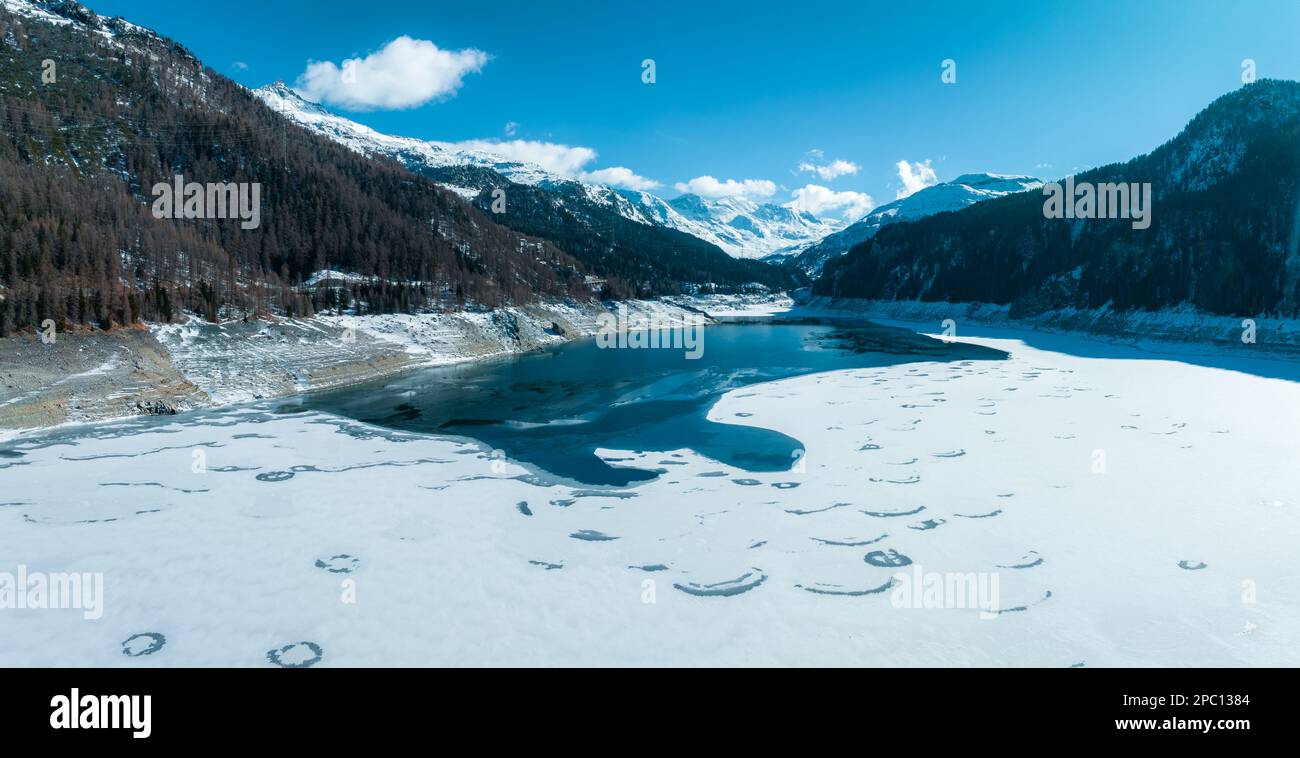Aerial view of the water dam and reservoir lake in Swiss Alps mountains ...