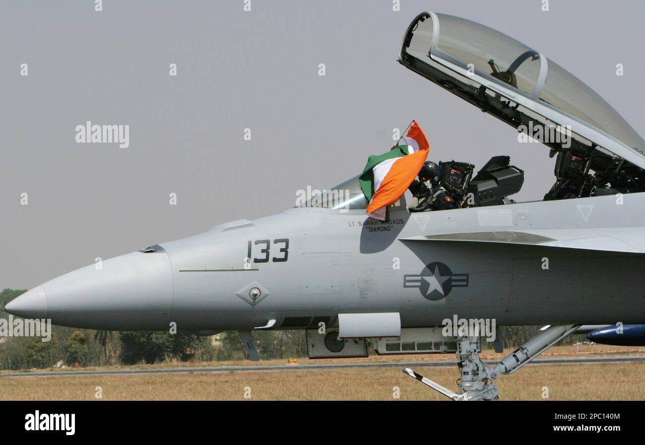 A U.S. Air Force pilot waves with an Indian flag from the cockpit of a ...