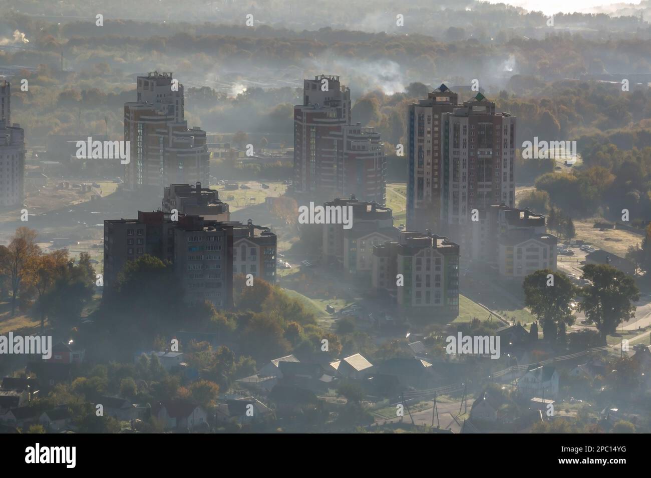 aerial view of green city with skysrapers and residential buildings in ...