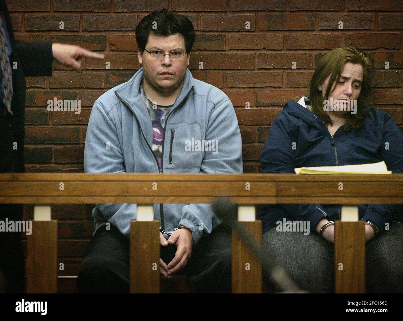 Michael Riley, 34, and his wife, Carolyn Riley, 32, are shown in Hingham District Court during ...