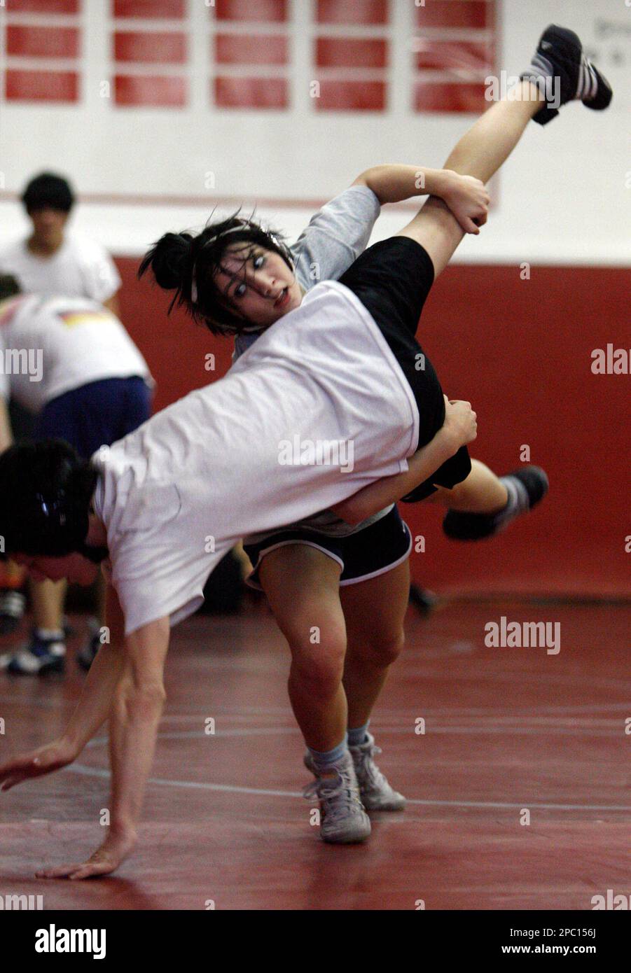Candace Workman wrestles with teammate Colby Christensen, below, during ...