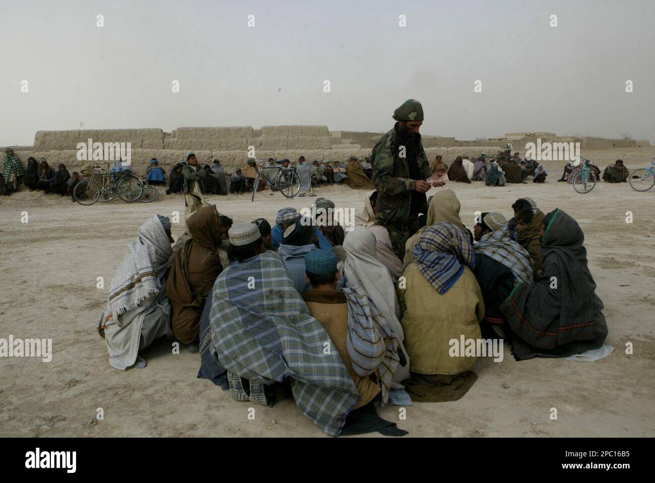 Afghan workers receive money from Afghan National Army officer in ...