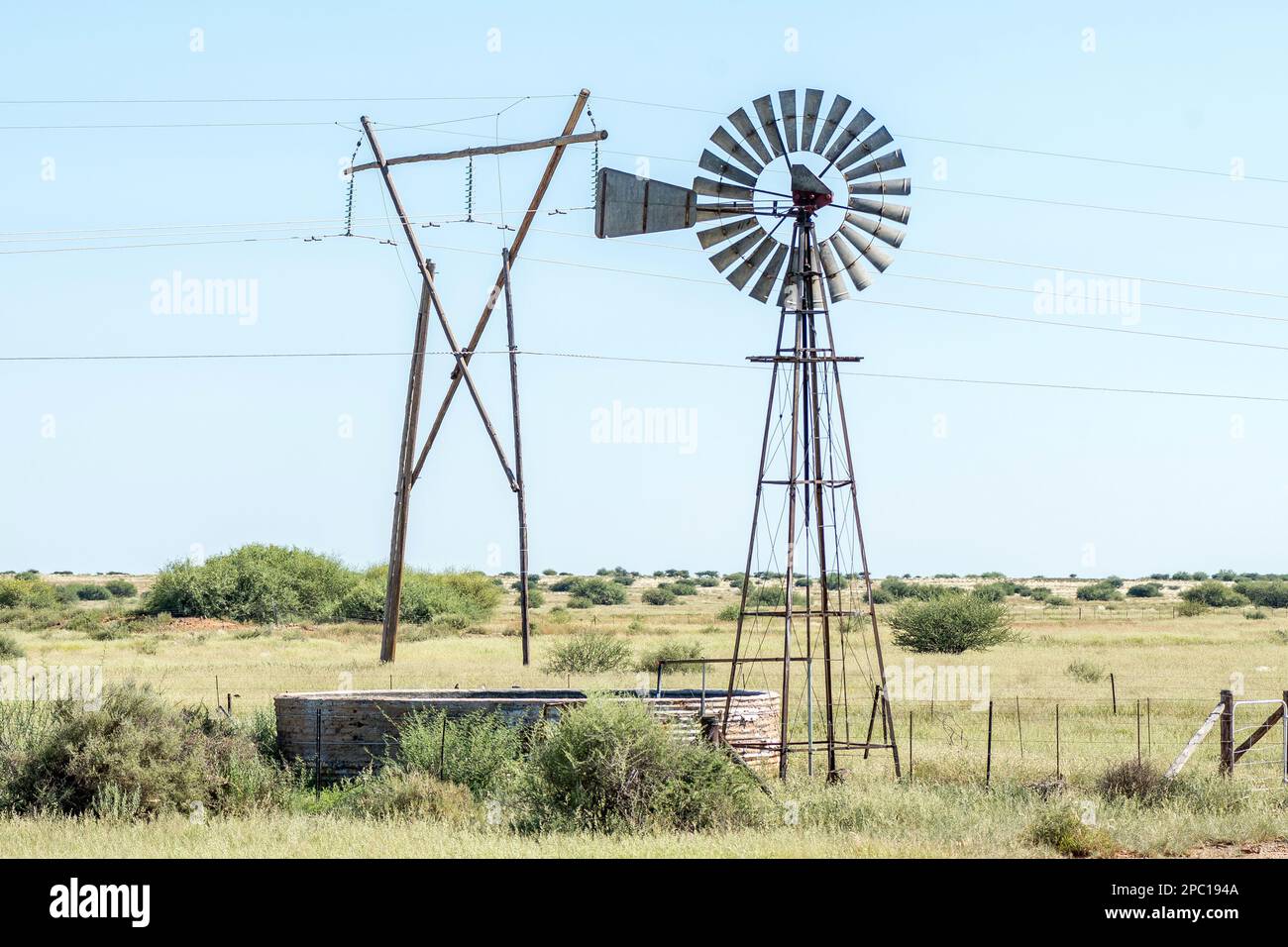 A windmill with dam and a electricity pylon between Douglas and Prieska ...