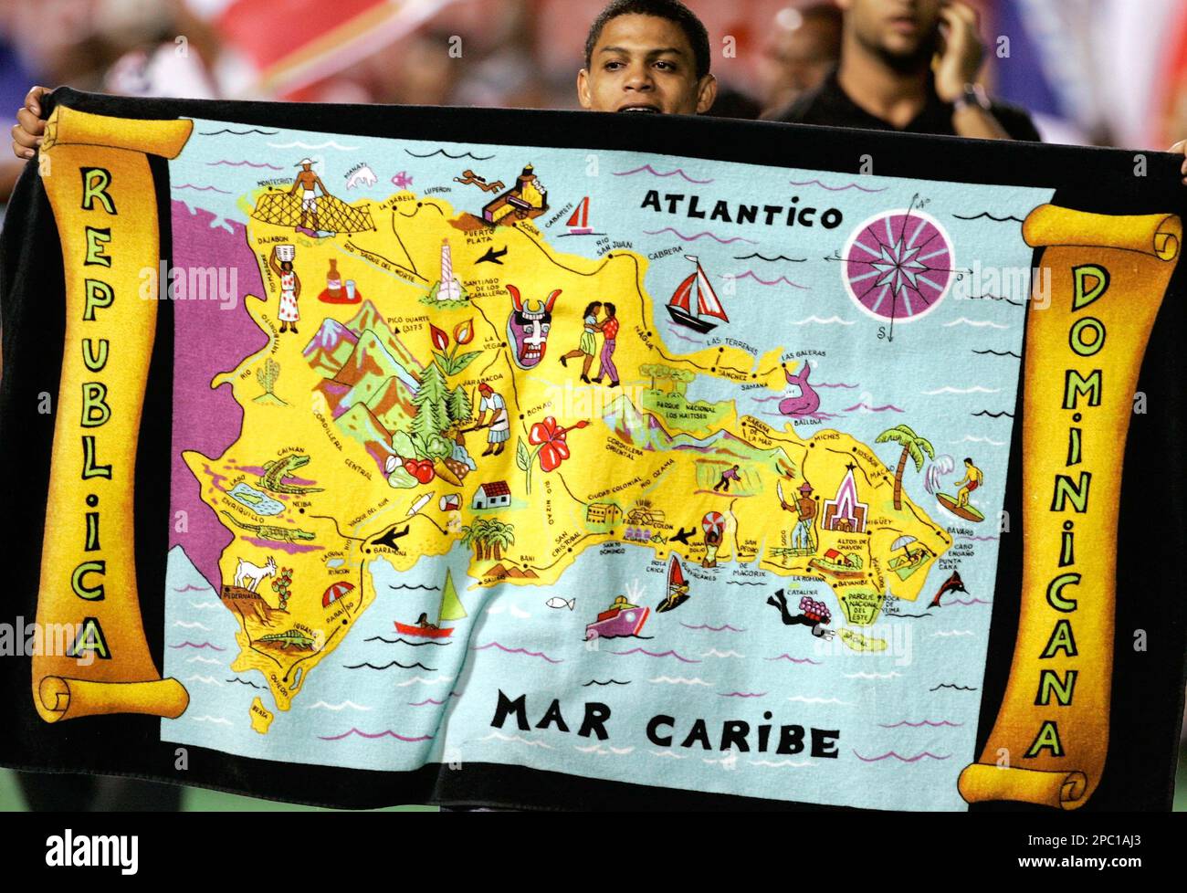 A Dominican Republic fan, displays a beach towel printed with a map of ...