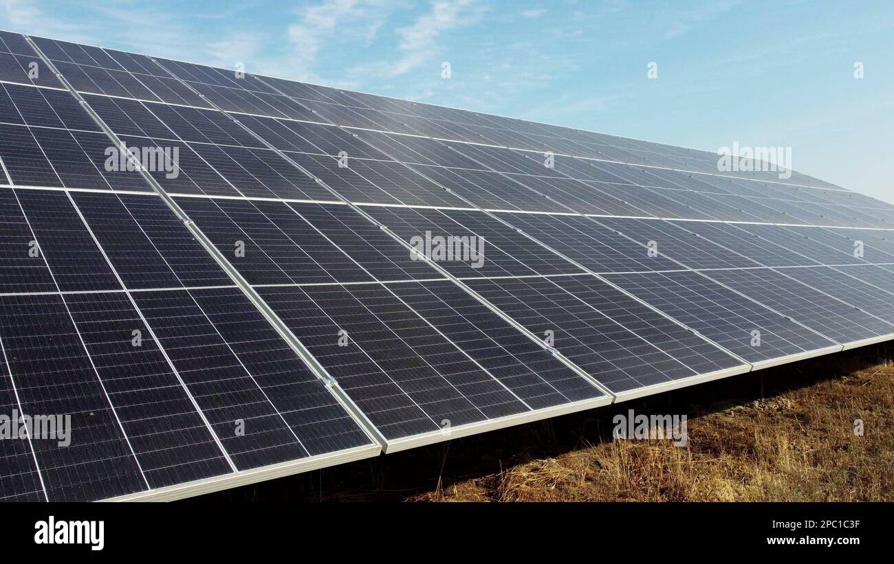 Solar power plant. Flight over modules of solar power station on sunny ...