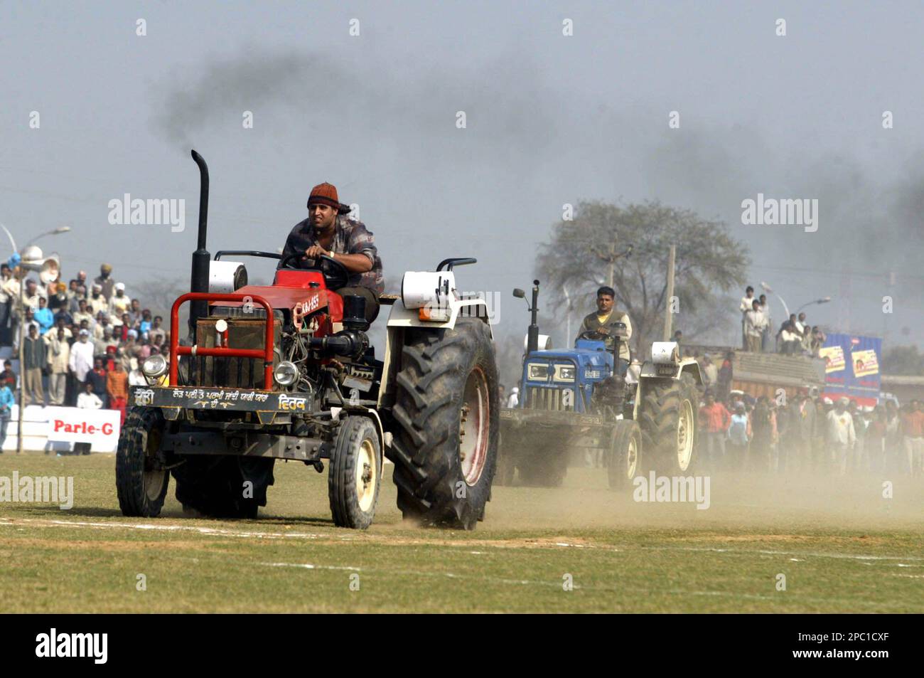 Indian farmers participate in a tractor race at the rural Olympics in ...