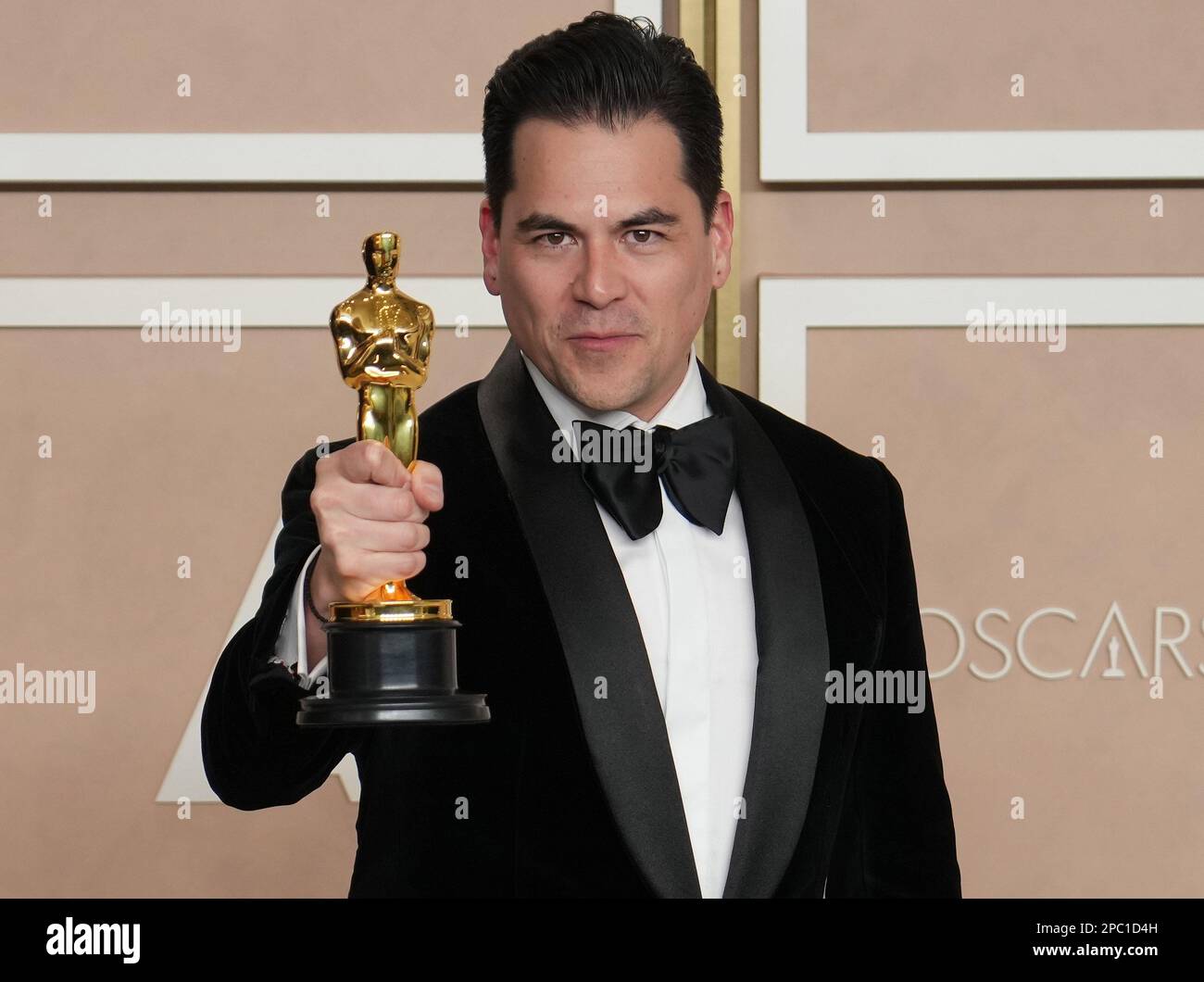 Los Angeles, USA. 12th Mar, 2023. Jonathan Wang poses with the Oscar for Best Picture for ...