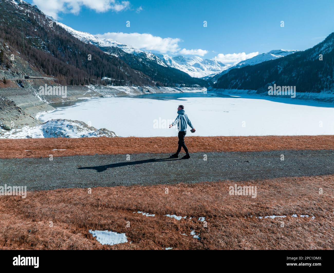 Young man walking down the beautiful scenery in Switzerland Stock Photo ...